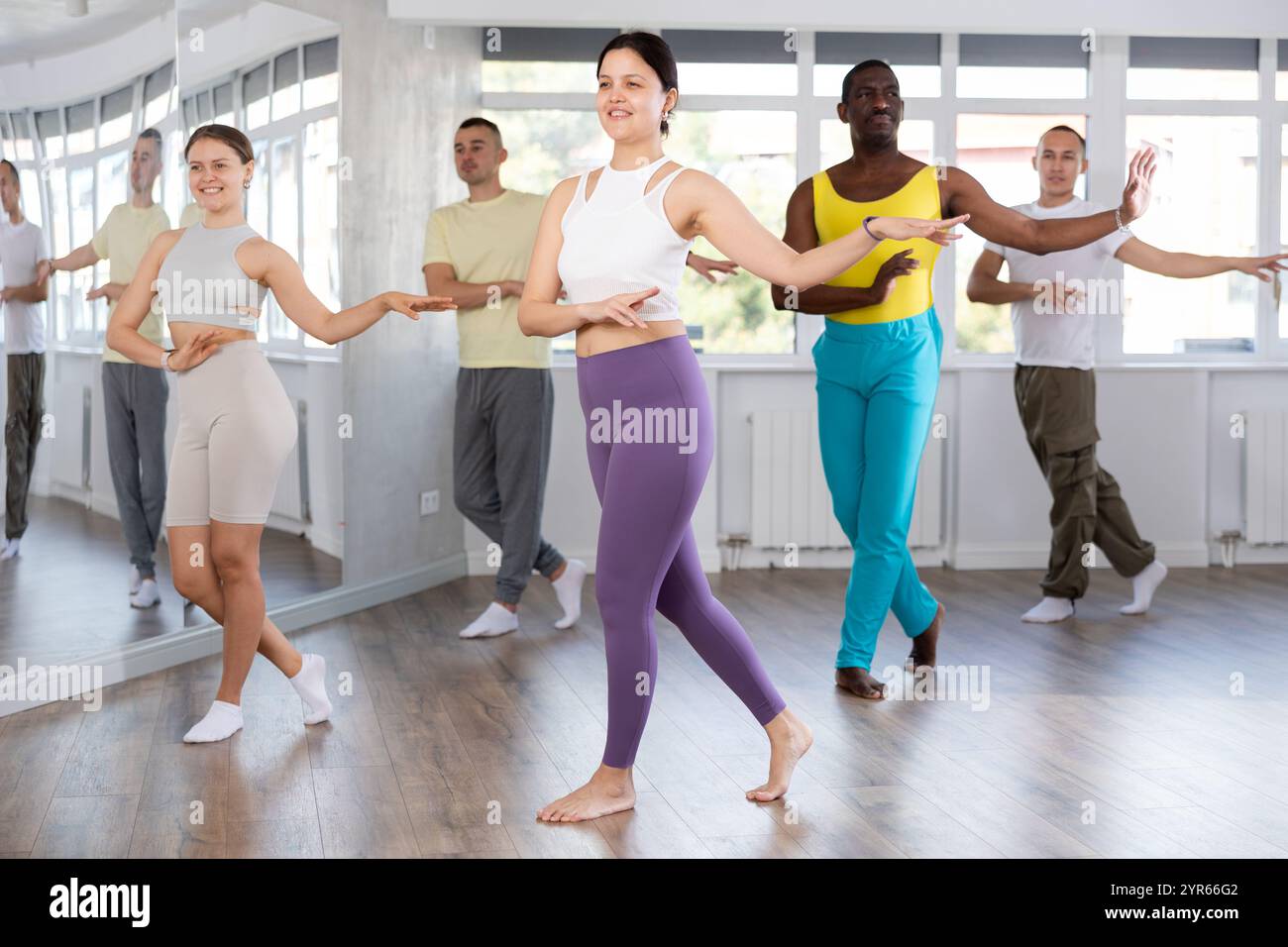 Young Asian woman dancing salsa during group class Stock Photo - Alamy