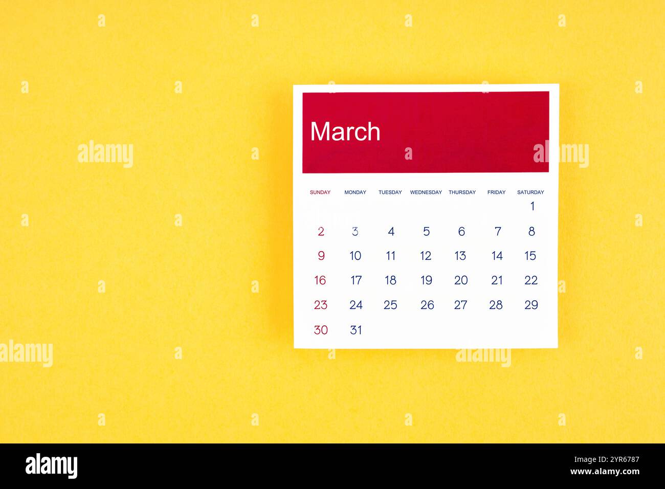 Calendar page March 2025 on yellow color background Stock Photo - Alamy