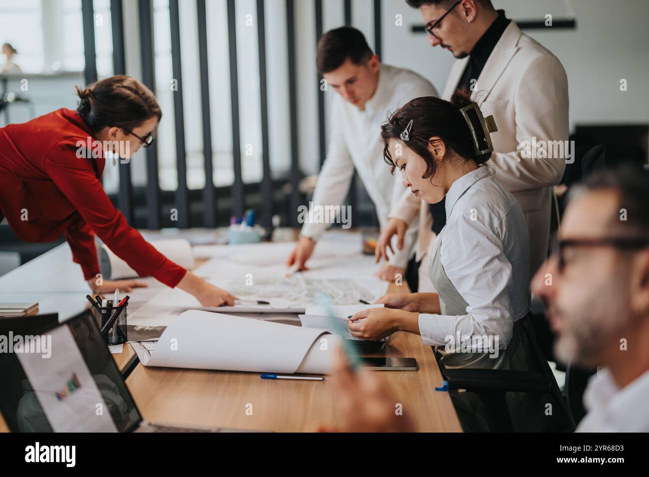 Team of business people strategizing in a modern office setting Stock ...