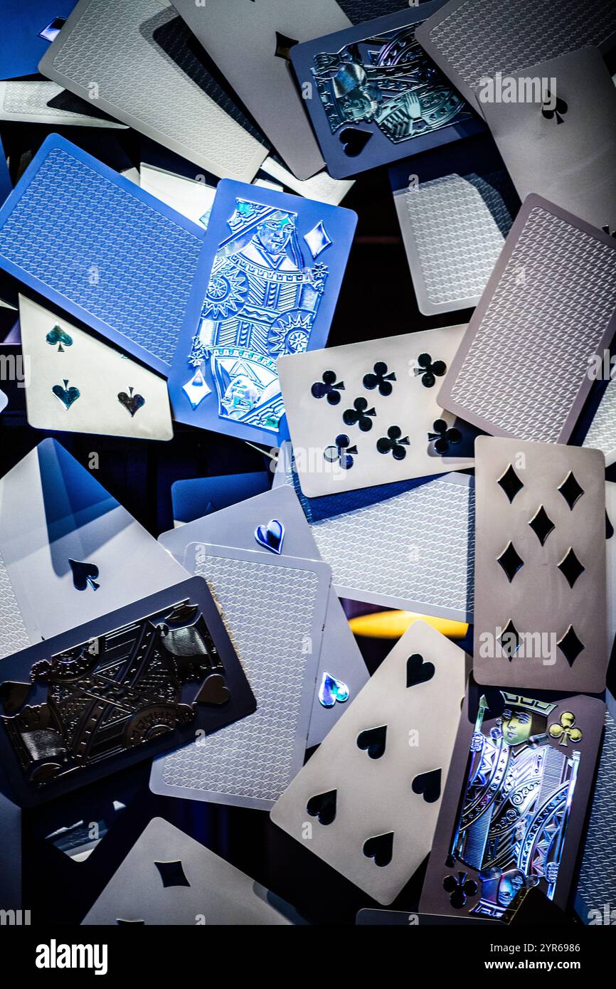 A collection of playing cards with a variety of suits and numbers. The ...