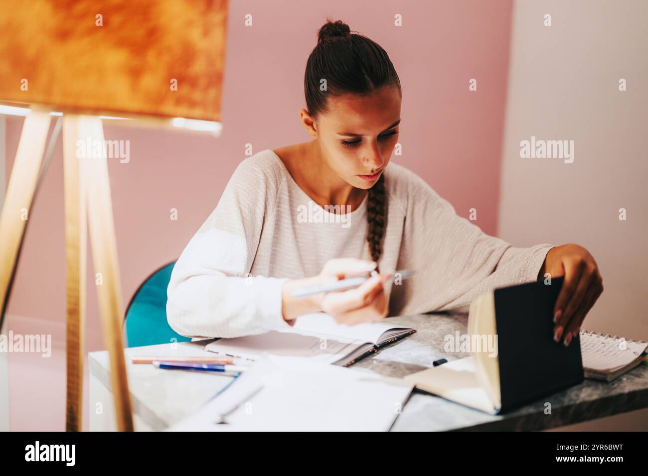 Young college student studying at home with focus and determination ...