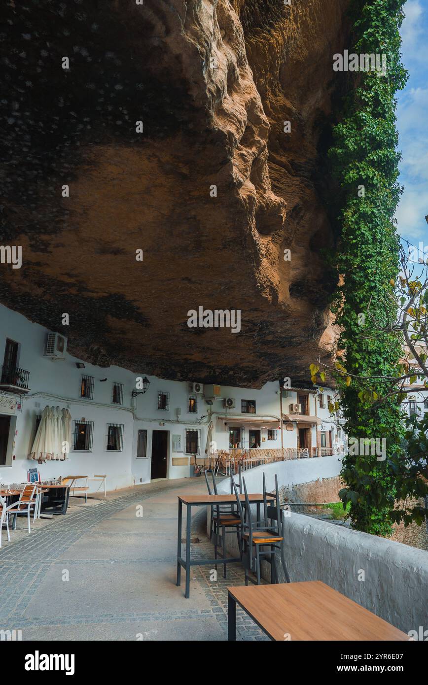 Whitewashed buildings are built into rock overhangs in Setenil De Las ...