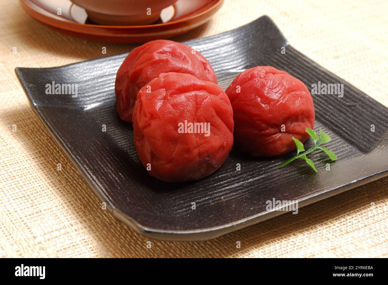 Pickled ume on a plate and tea Stock Photo - Alamy