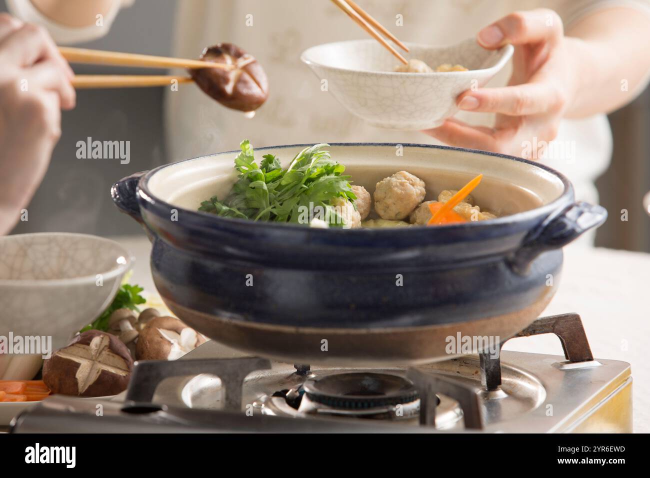 Eating together around the chanko-nabe Stock Photo - Alamy