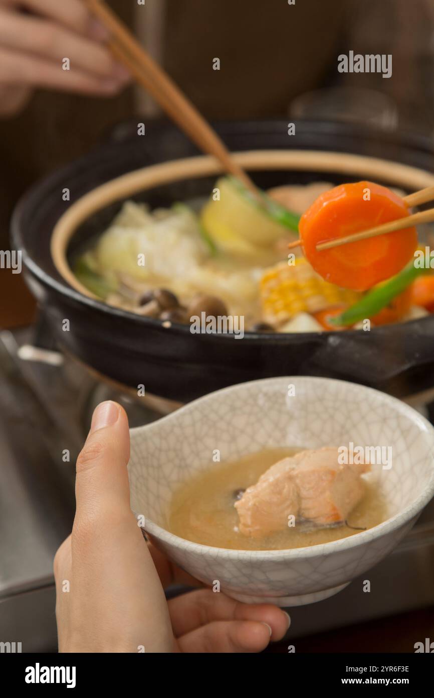 Eating around Hokkaido-style Ishikari nabe Stock Photo - Alamy