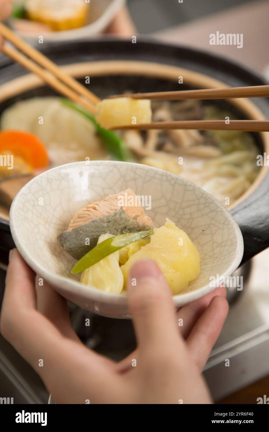 Eating around Hokkaido-style Ishikari nabe Stock Photo - Alamy