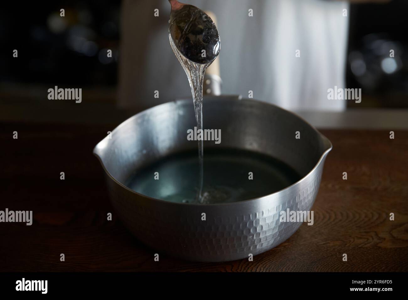 Add syrup to the coloured agar liquid2 Stock Photo - Alamy