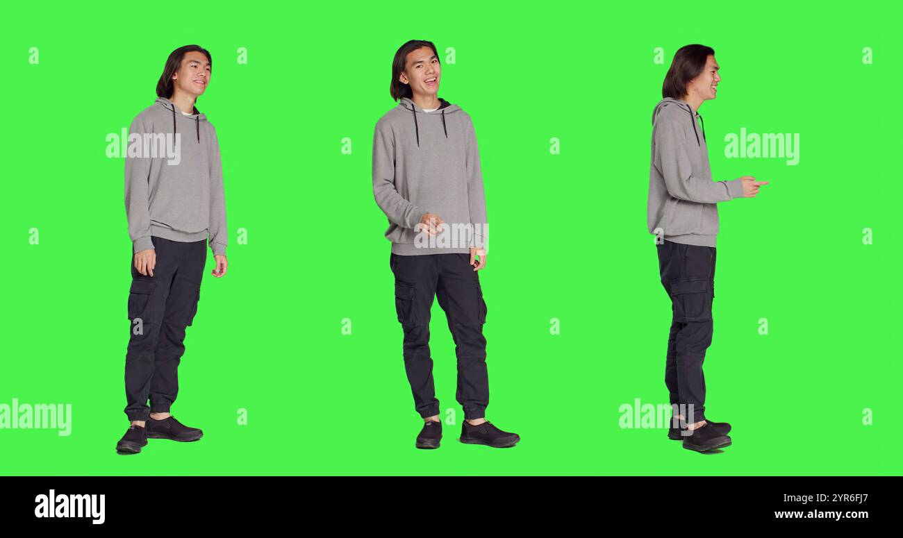 Asian adult shows agreement symbol over greenscreen full body ...