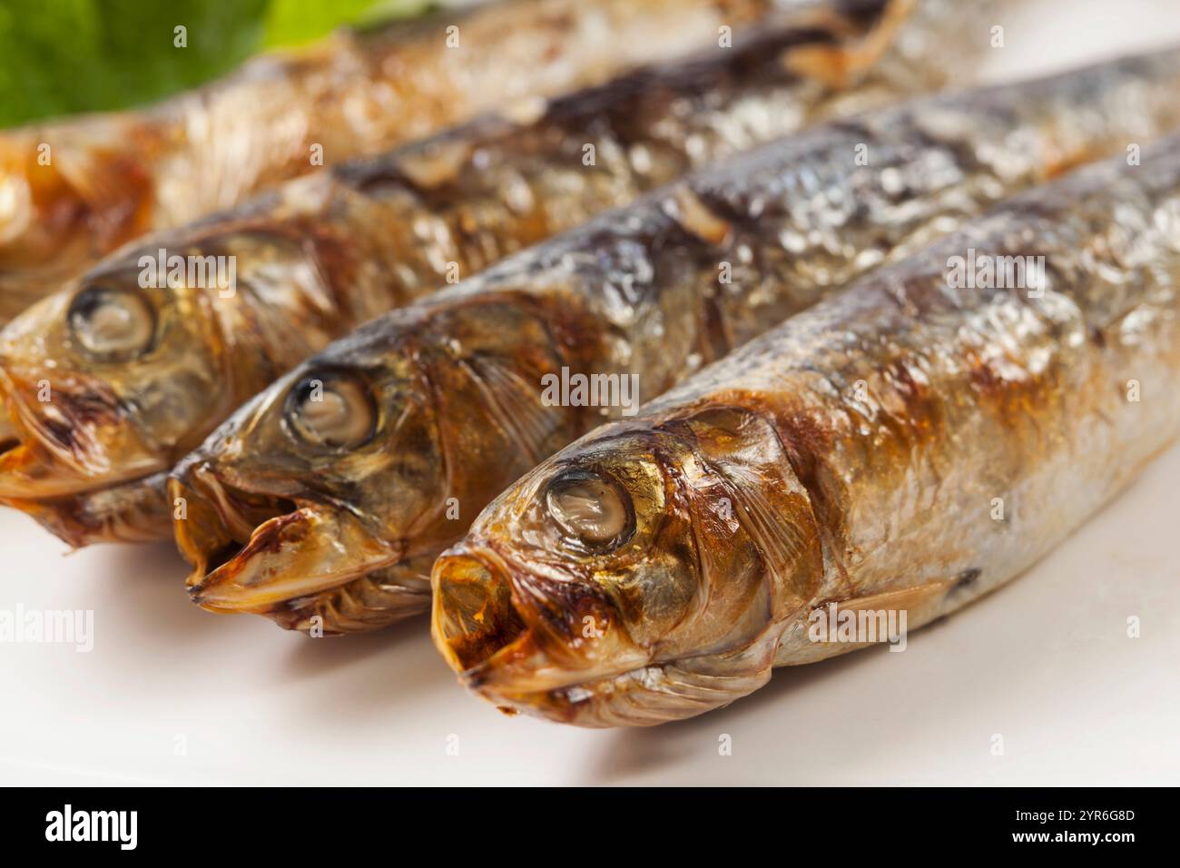 Grilled whole dried sardines Stock Photo - Alamy