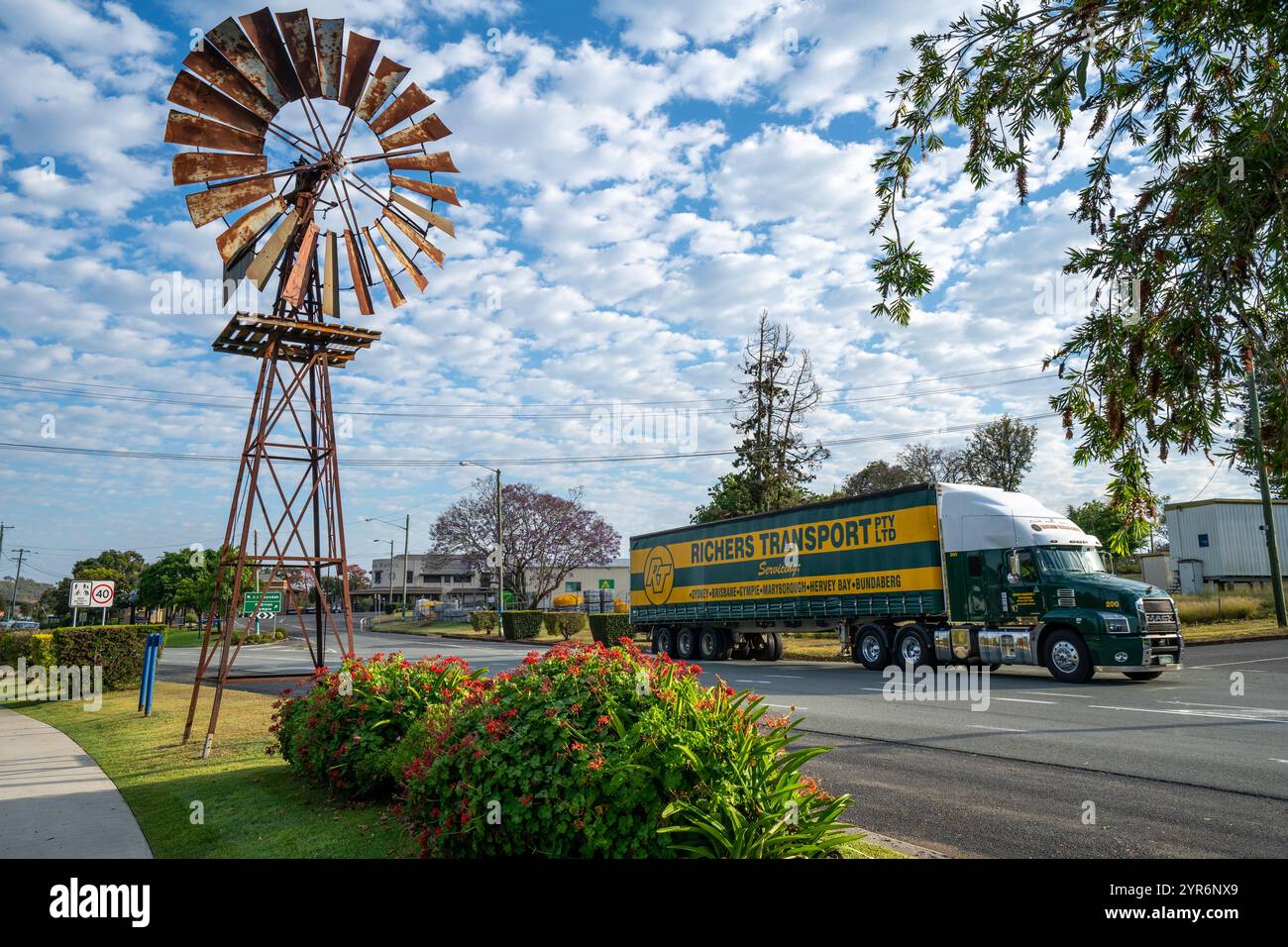 Truck passing large windmill on display outside Tourist Information ...