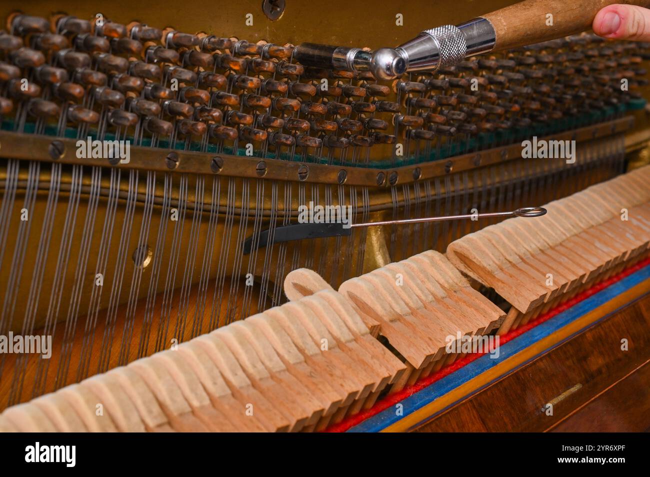 The piano tuner adjusts the piano with the tool Stock Photo - Alamy