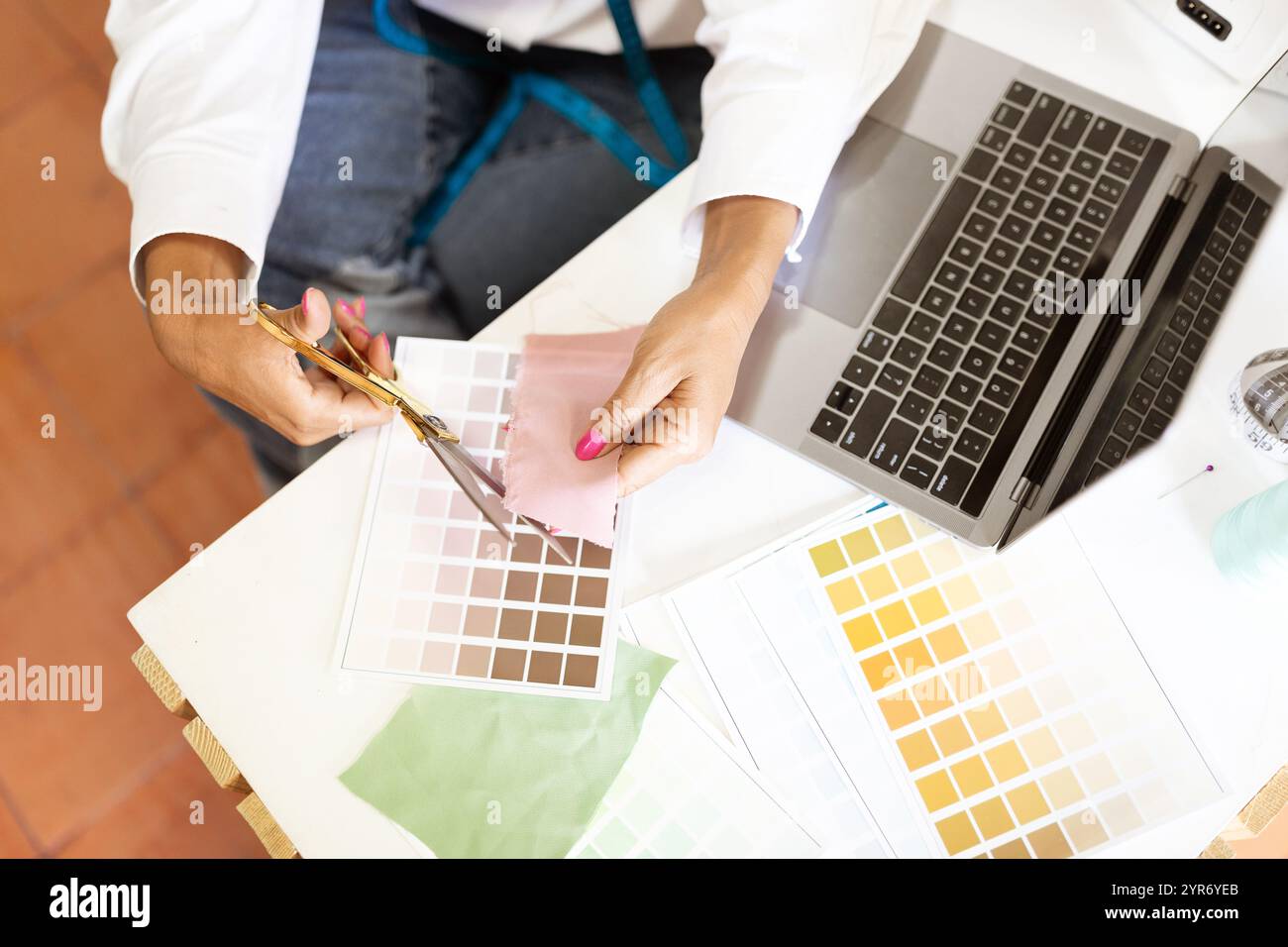 Creative designer working on fabric swatches and color palettes in her ...