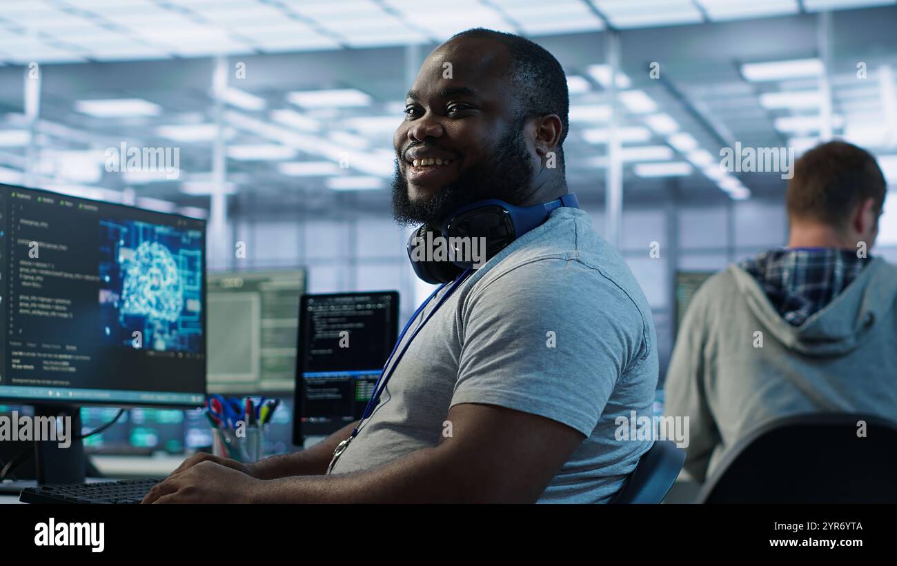 Happy engineer laughing at coworker joke while working in high tech AI ...