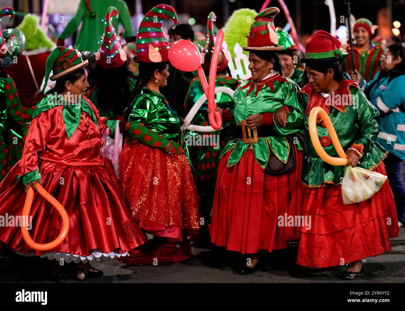 Aymara women dressed as elves dance during the annual Christmas Parade ...