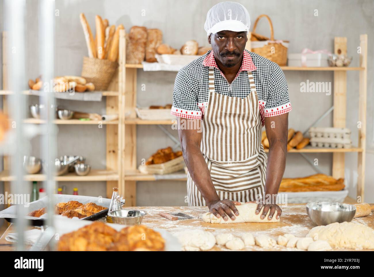 African American baker kneading dough in artisan bakery Stock Photo - Alamy