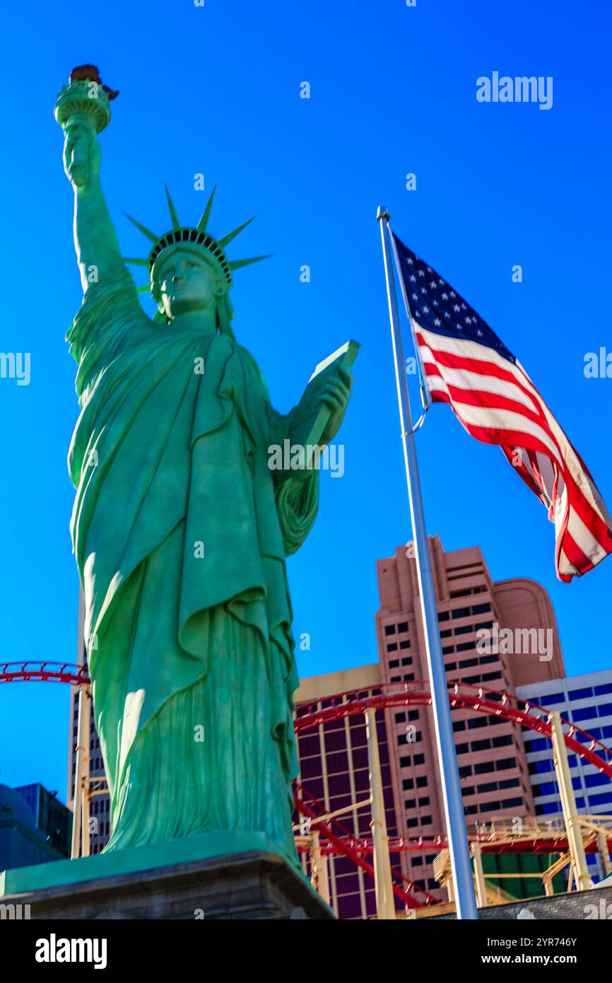 A statue of a woman holding a torch and a flag is standing in front of ...