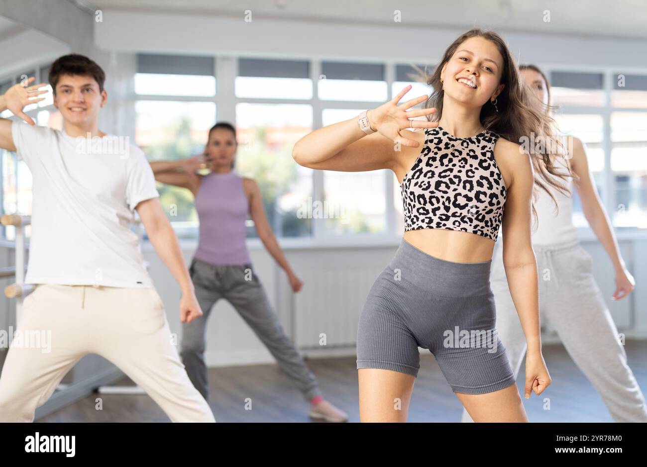 Young girl practicing hip-hop dance in training hall in group Stock ...