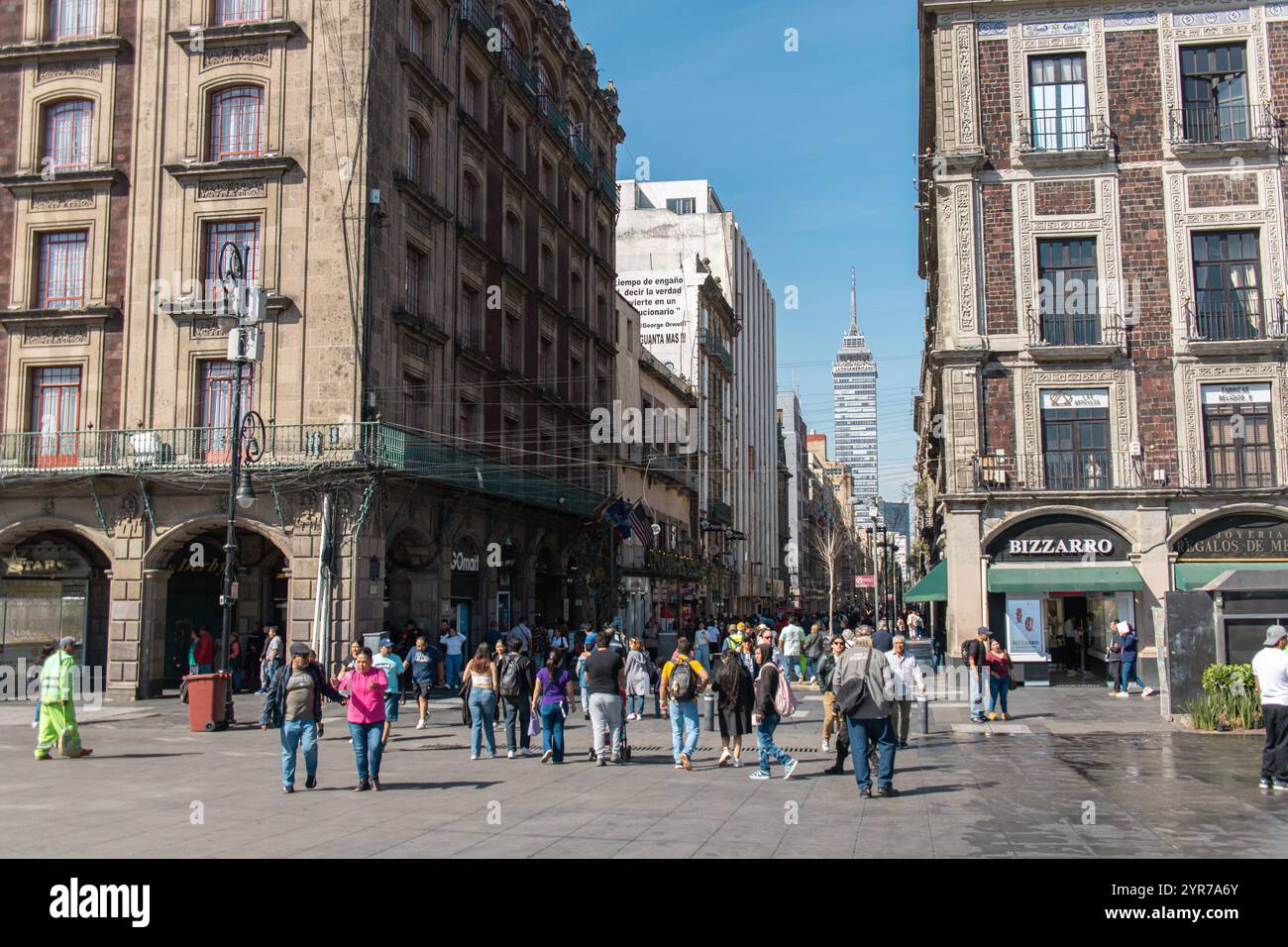 A lively street in downtown Mexico City with historic buildings, shops ...