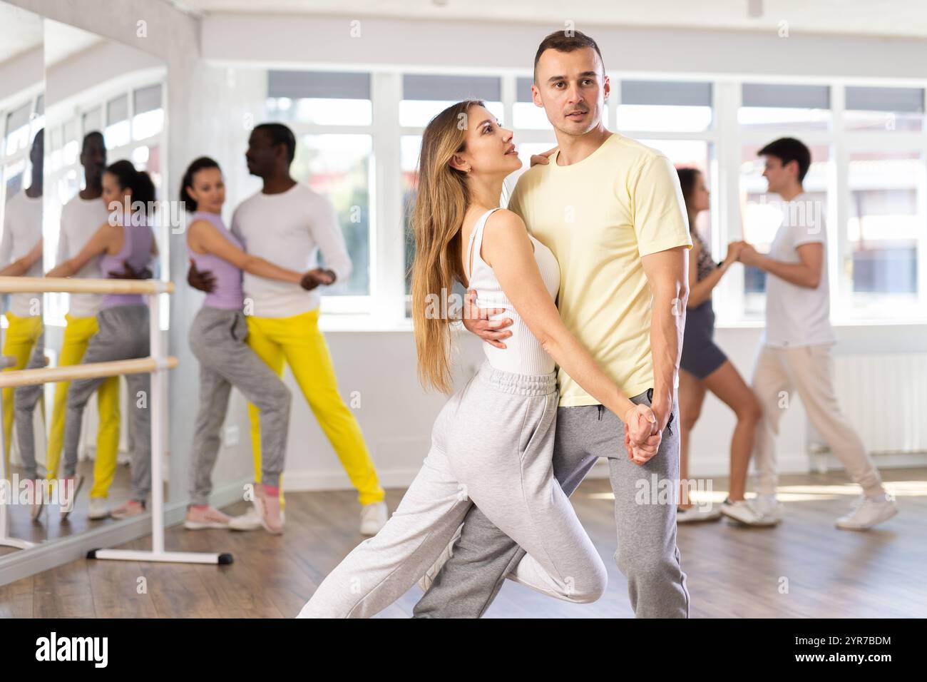 Group of women and men learning to dance latin dances in dance studio Stock Photo - Alamy