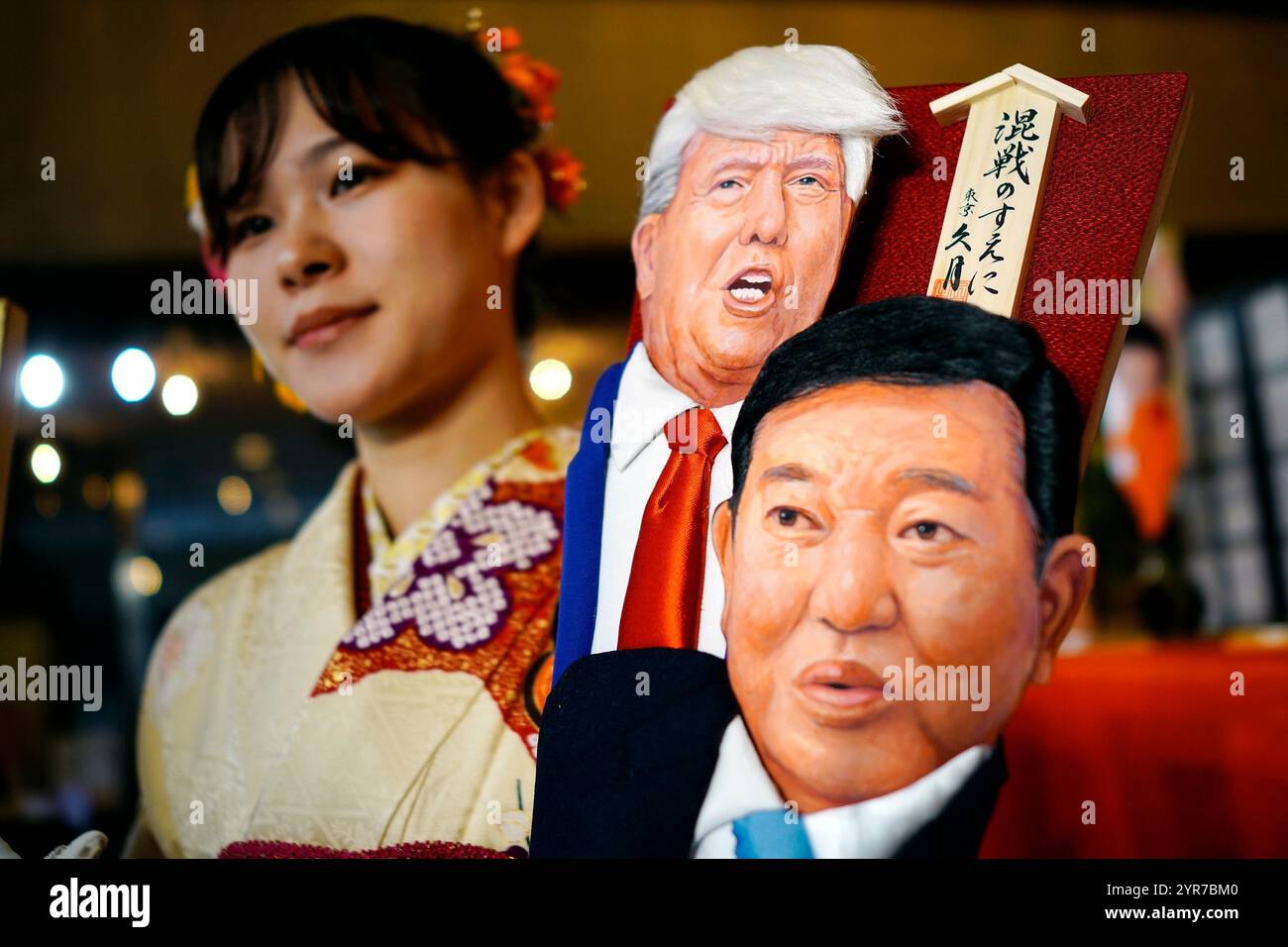 An employee of Kyugetsu, a Japanese traditional doll company, poses ...