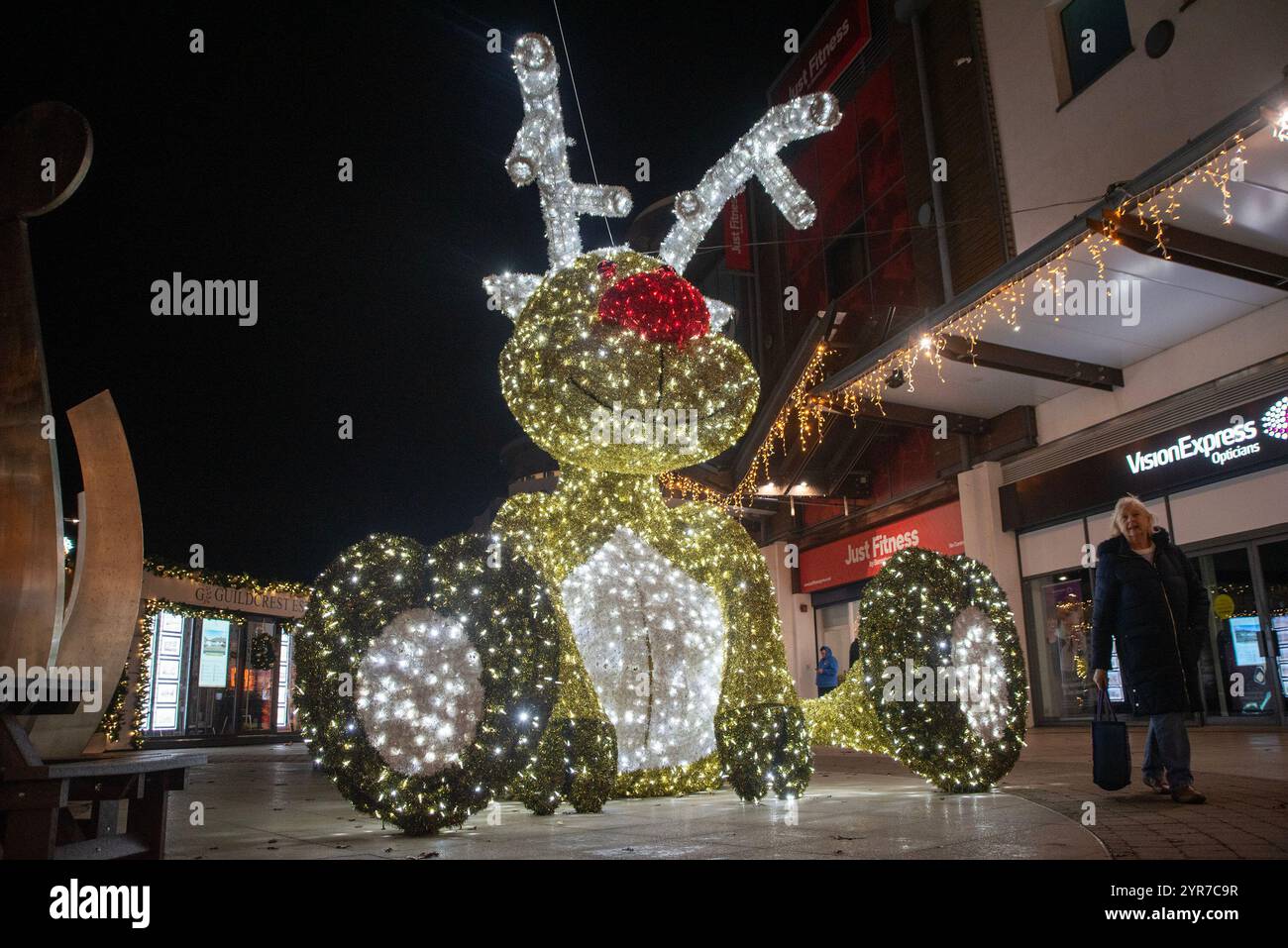 A woman walk by the giant sitting Rudolph, the red nosed reindeer at ...