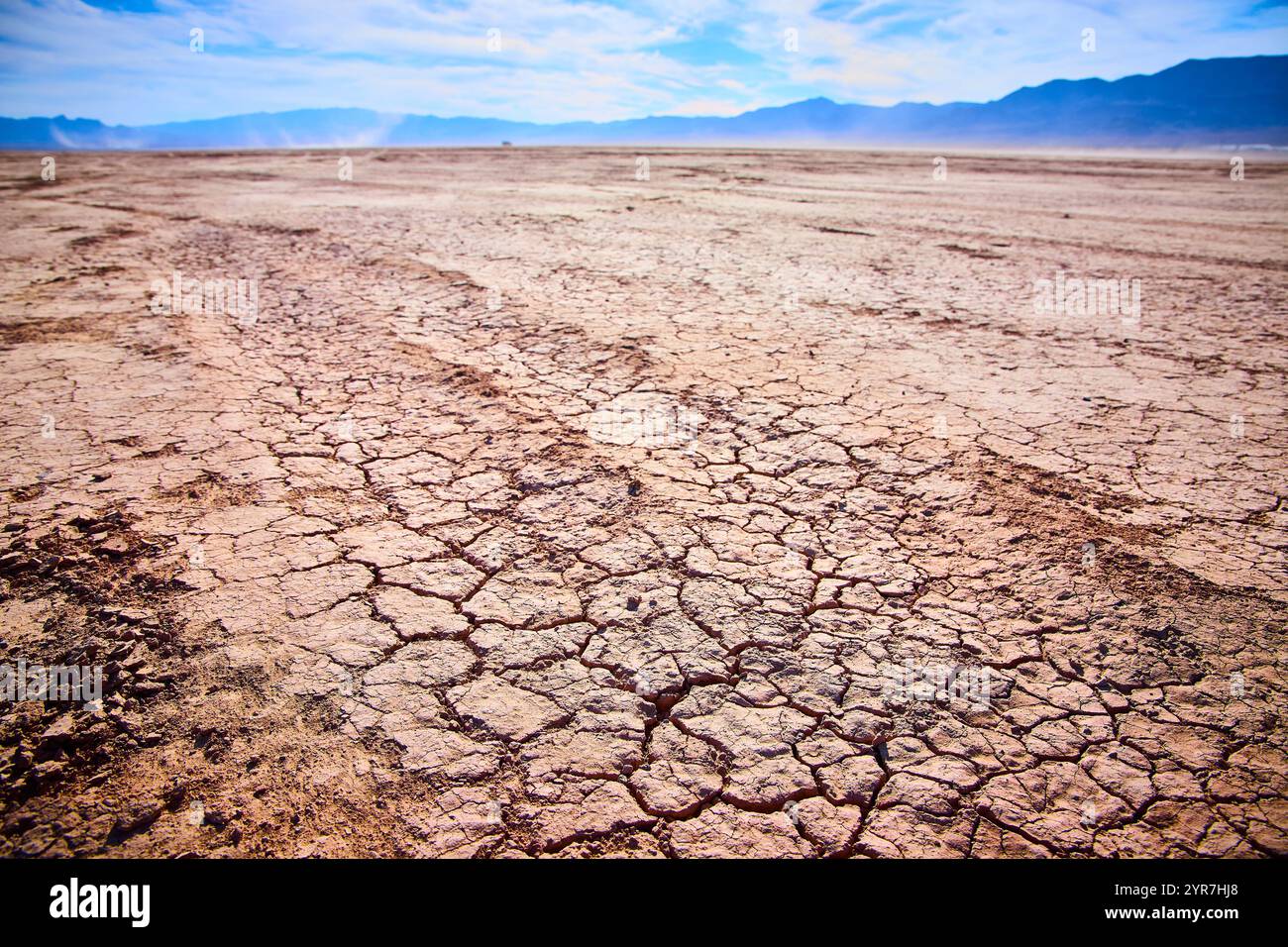 Cracked Desert Landscape with Distant Mountains Low Eye-Level View ...