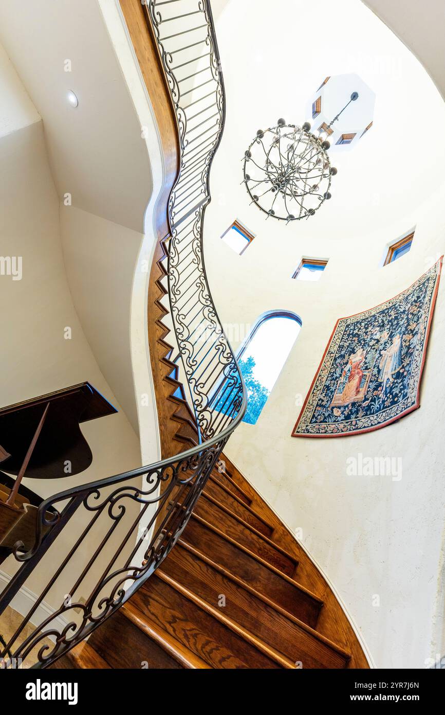 Elegant spiral staircase with intricate design and beautiful chandelier Stock Photo - Alamy