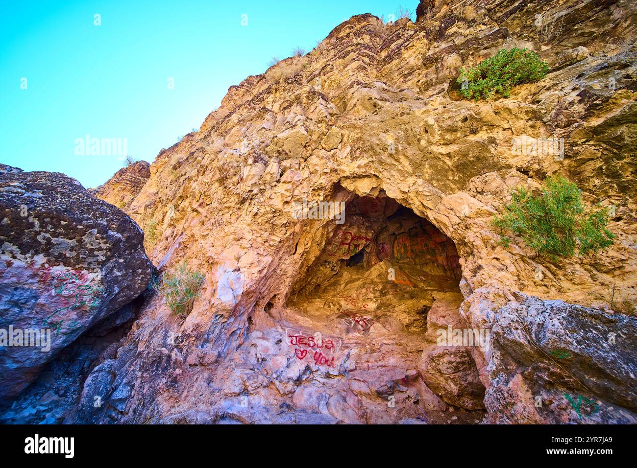 Rugged Cave Entrance with Graffiti in Golden Light Eye-Level View Stock ...