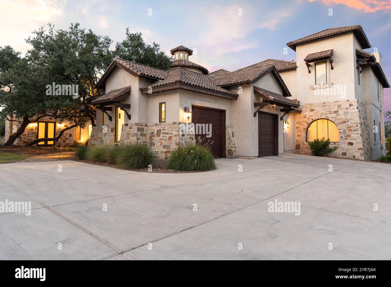 Elegant modern home with stone accents and a spacious driveway at ...