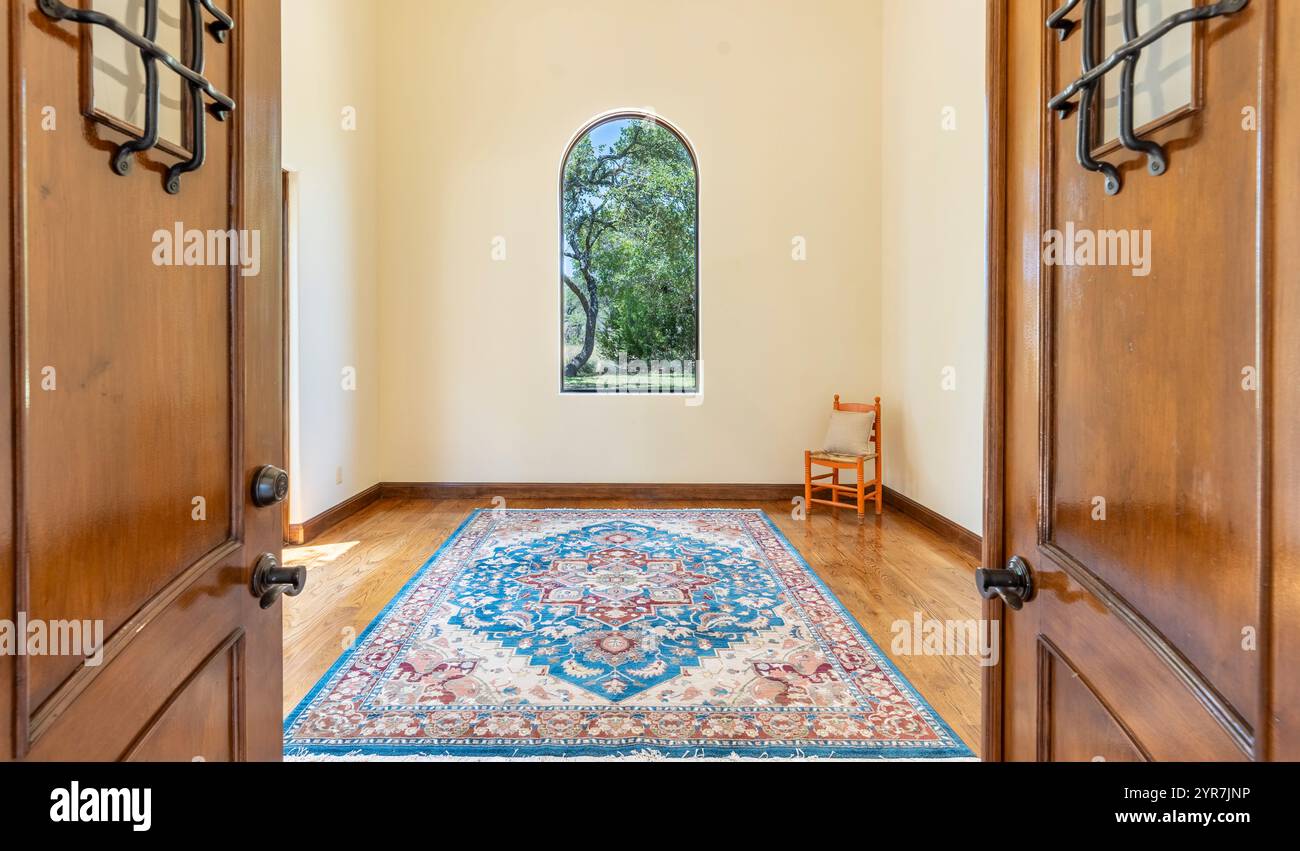 Cozy interior with wooden doors and a patterned rug in a serene setting ...