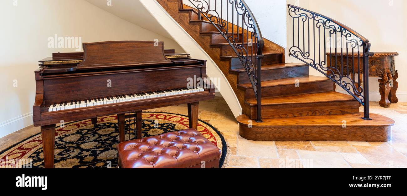 Elegant wooden staircase with grand piano in luxurious interior setting ...