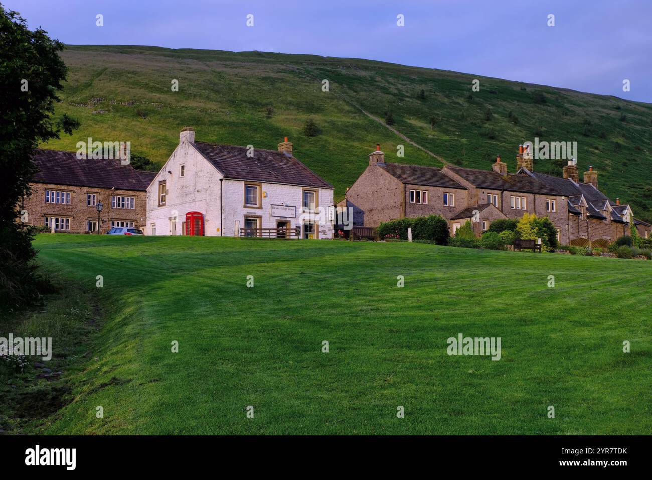 Buckden: Village green with houses, village store and red telephone box ...