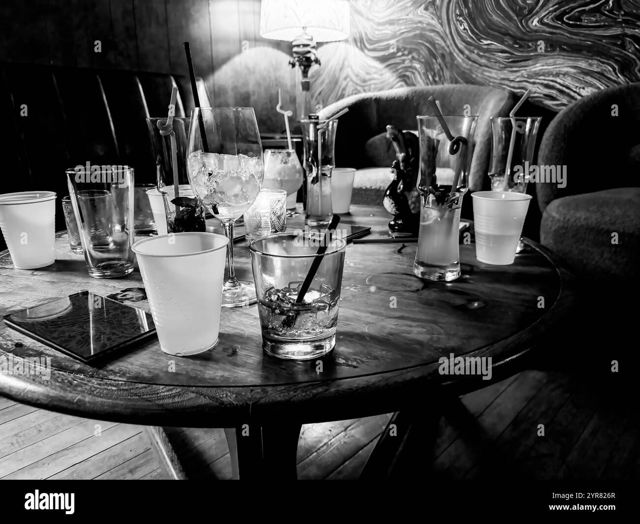 Scattered glasses and empty drinks on a bar table after a party Stock ...