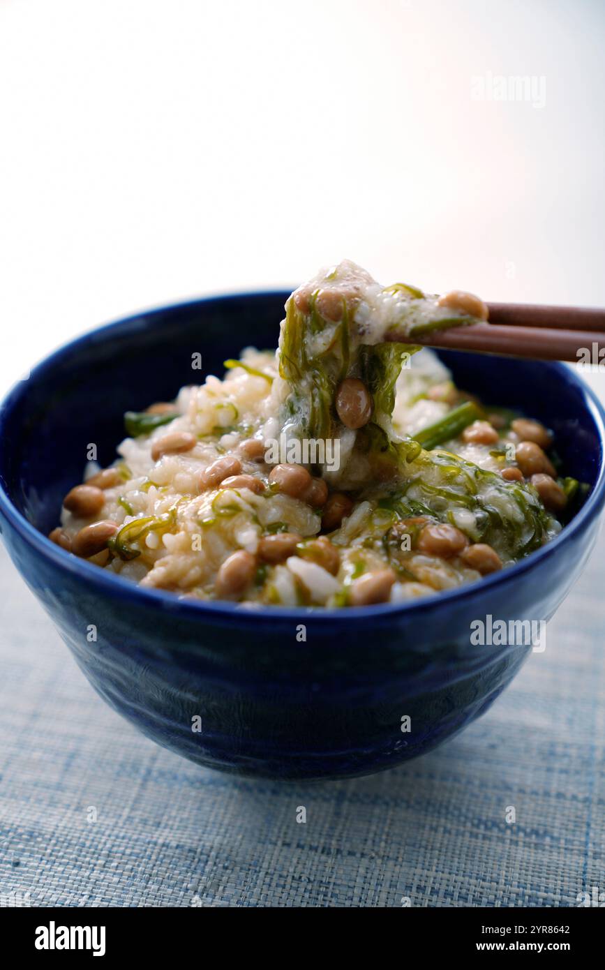 Rice with natto and Mekabu, lifted up with chopsticks Stock Photo - Alamy
