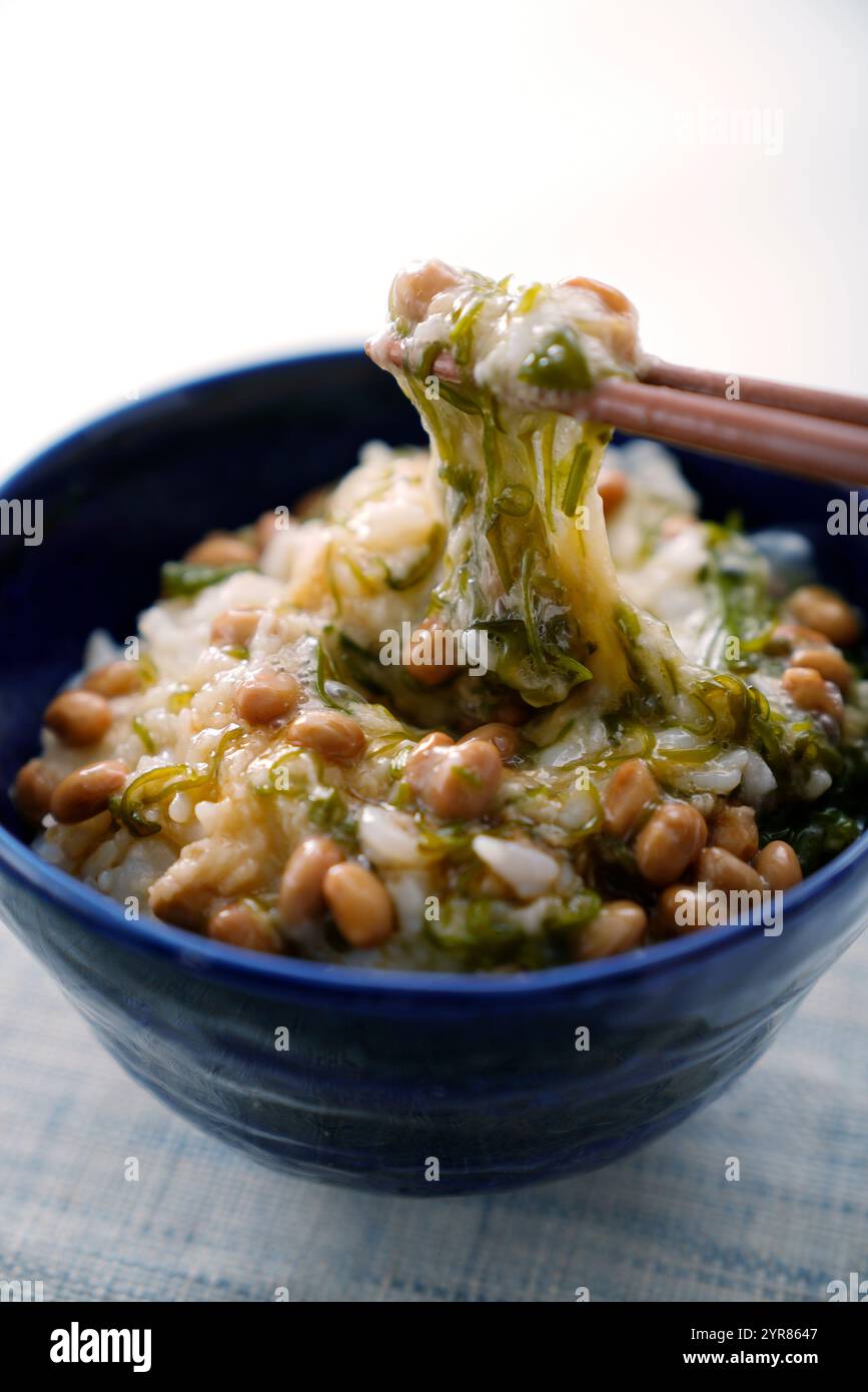 Rice with natto and Mekabu, lifted up with chopsticks Stock Photo - Alamy
