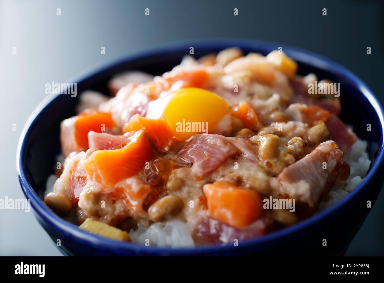 Bowl of rice topped with seafood, natto and egg Stock Photo - Alamy