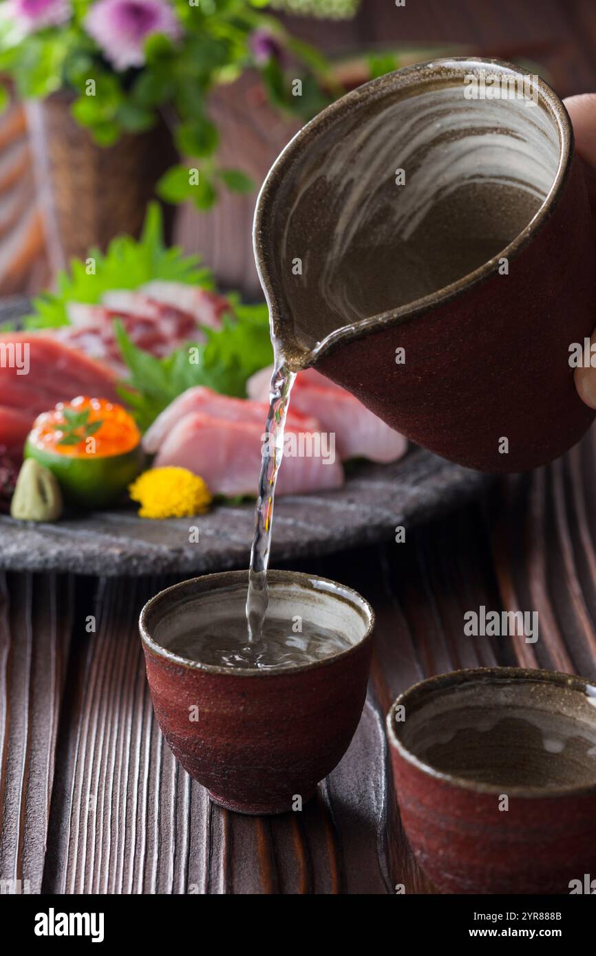 Sake and 4 sashimi Stock Photo - Alamy
