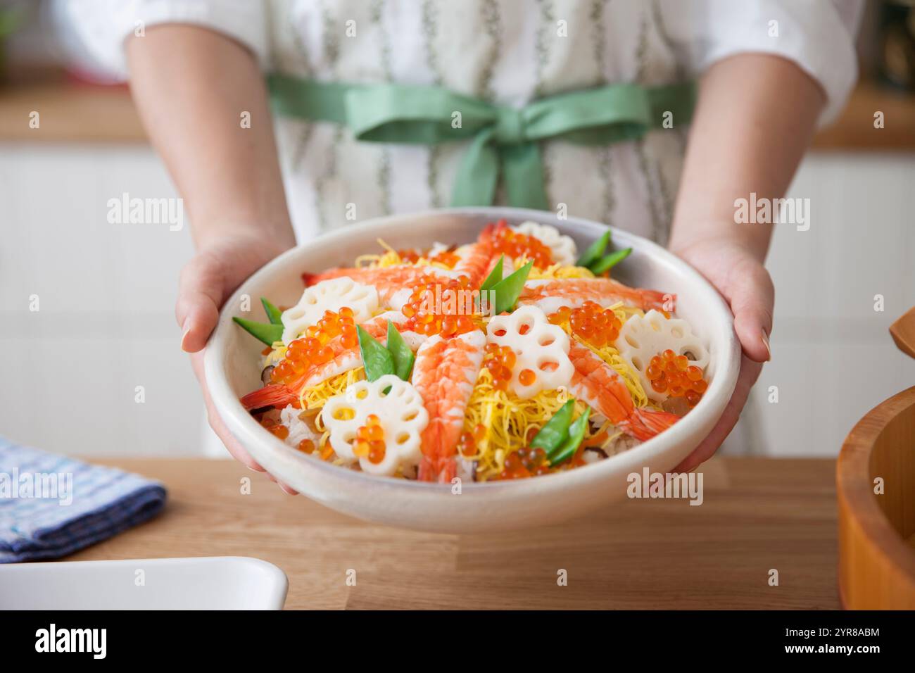 Woman holding plate of cooked chirashi-zushi Stock Photo - Alamy