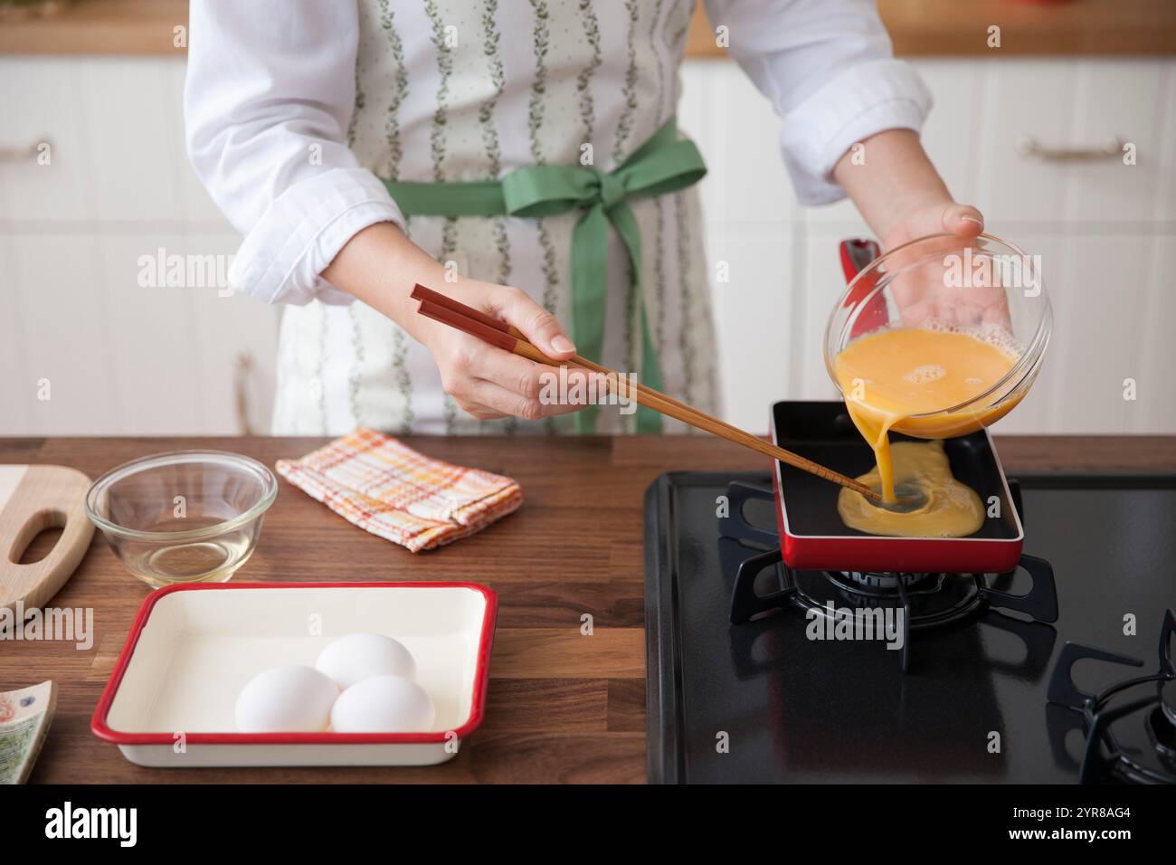 Woman pouring egg liquid hi-res stock photography and images - Alamy