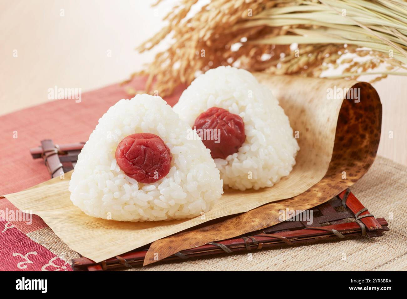 Rice ball (with ume plum) and ears of rice Stock Photo - Alamy