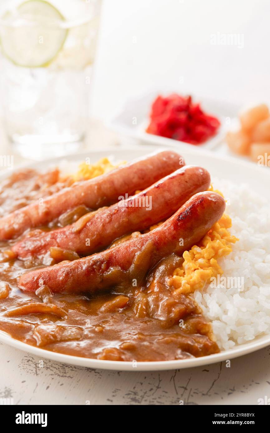 Curry rice topped with sausage and scrambled eggs Stock Photo - Alamy
