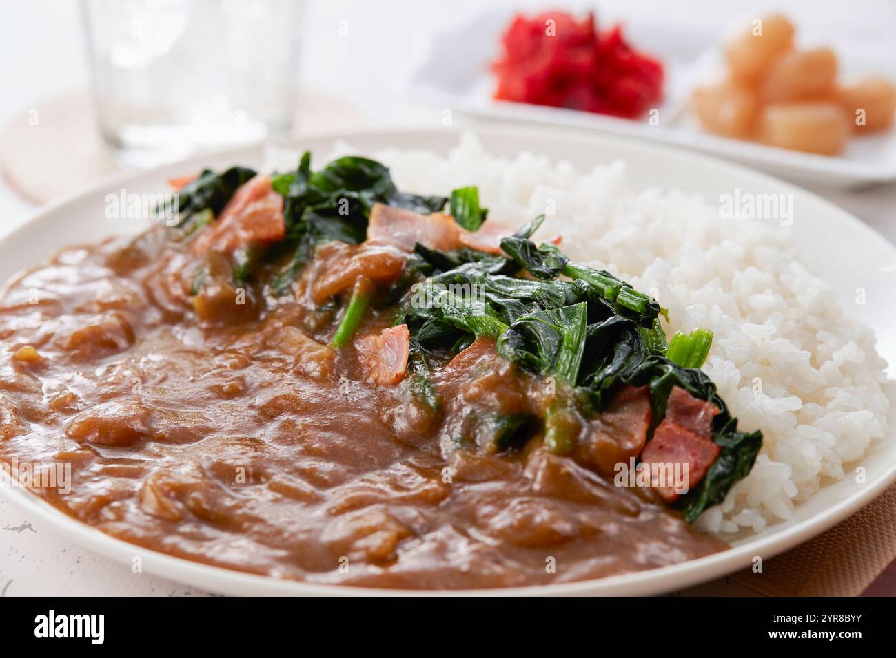 Curry rice with spinach topping Stock Photo - Alamy