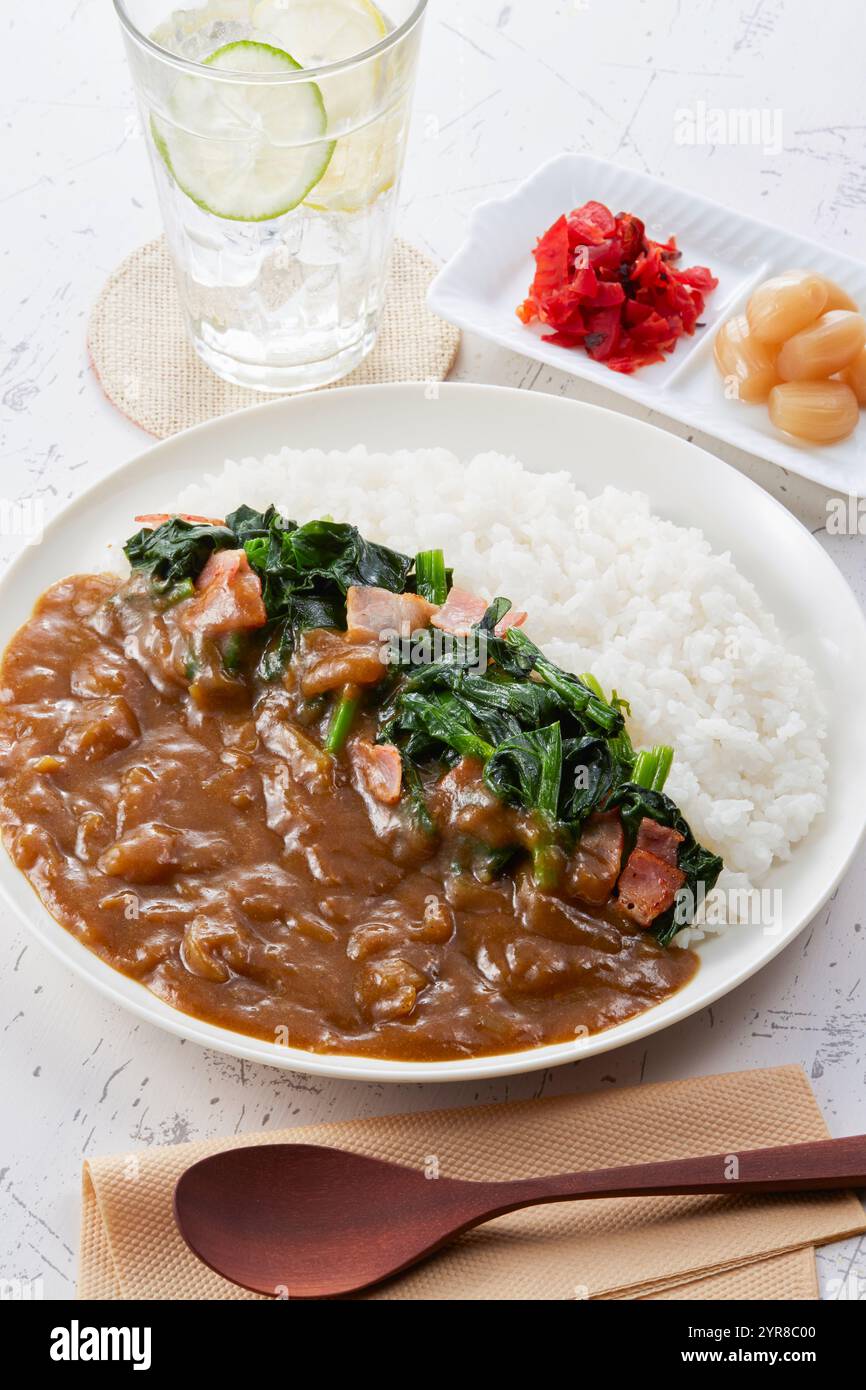 Curry rice with spinach topping Stock Photo - Alamy