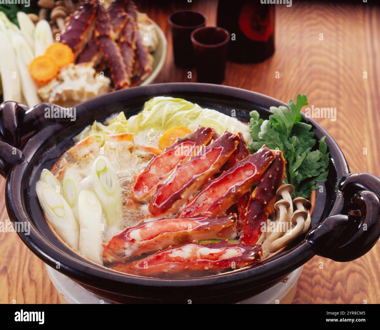 Dining table with crab hotpot Stock Photo - Alamy