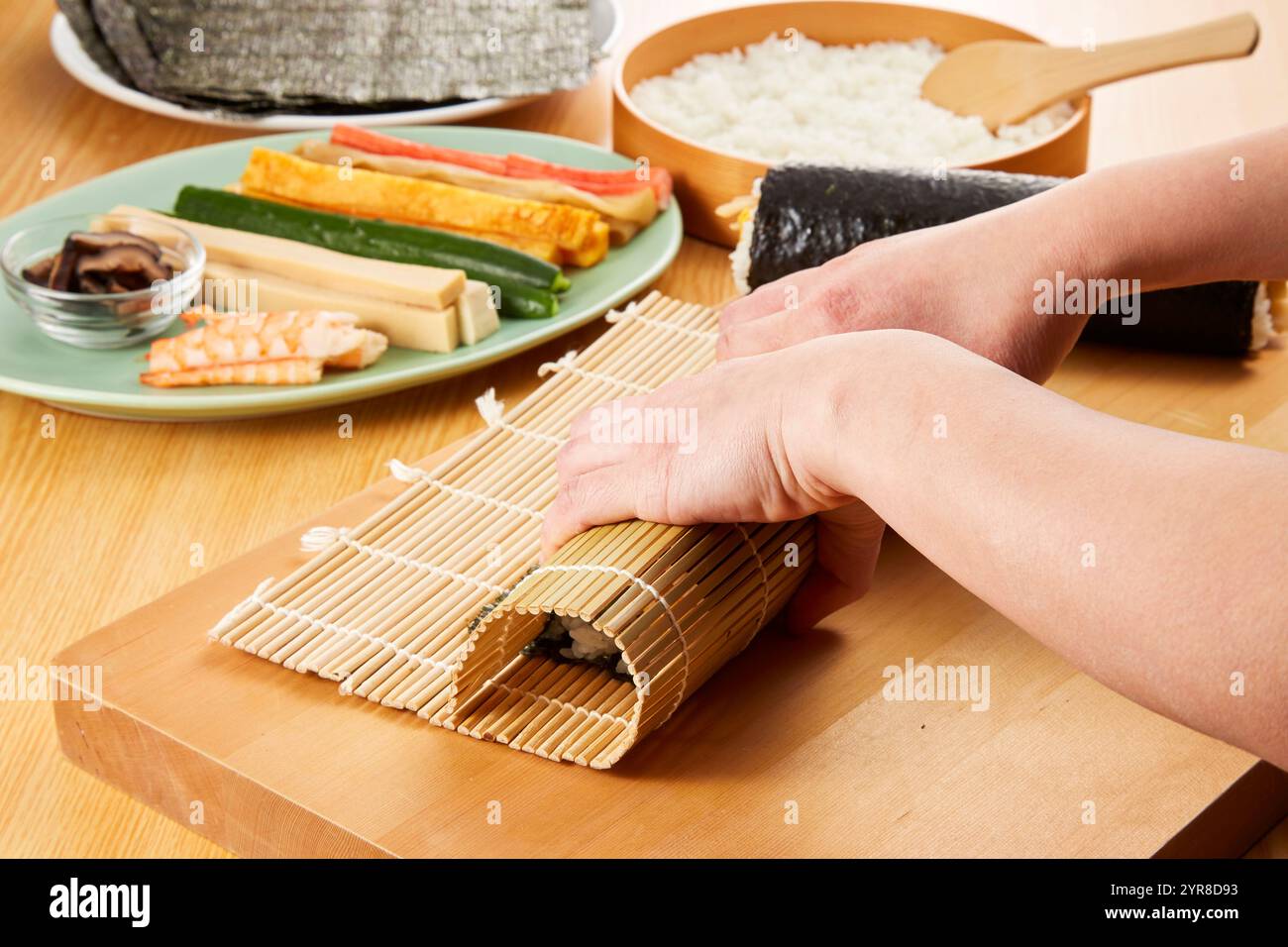Rolled sushi Cooking scene Stock Photo - Alamy