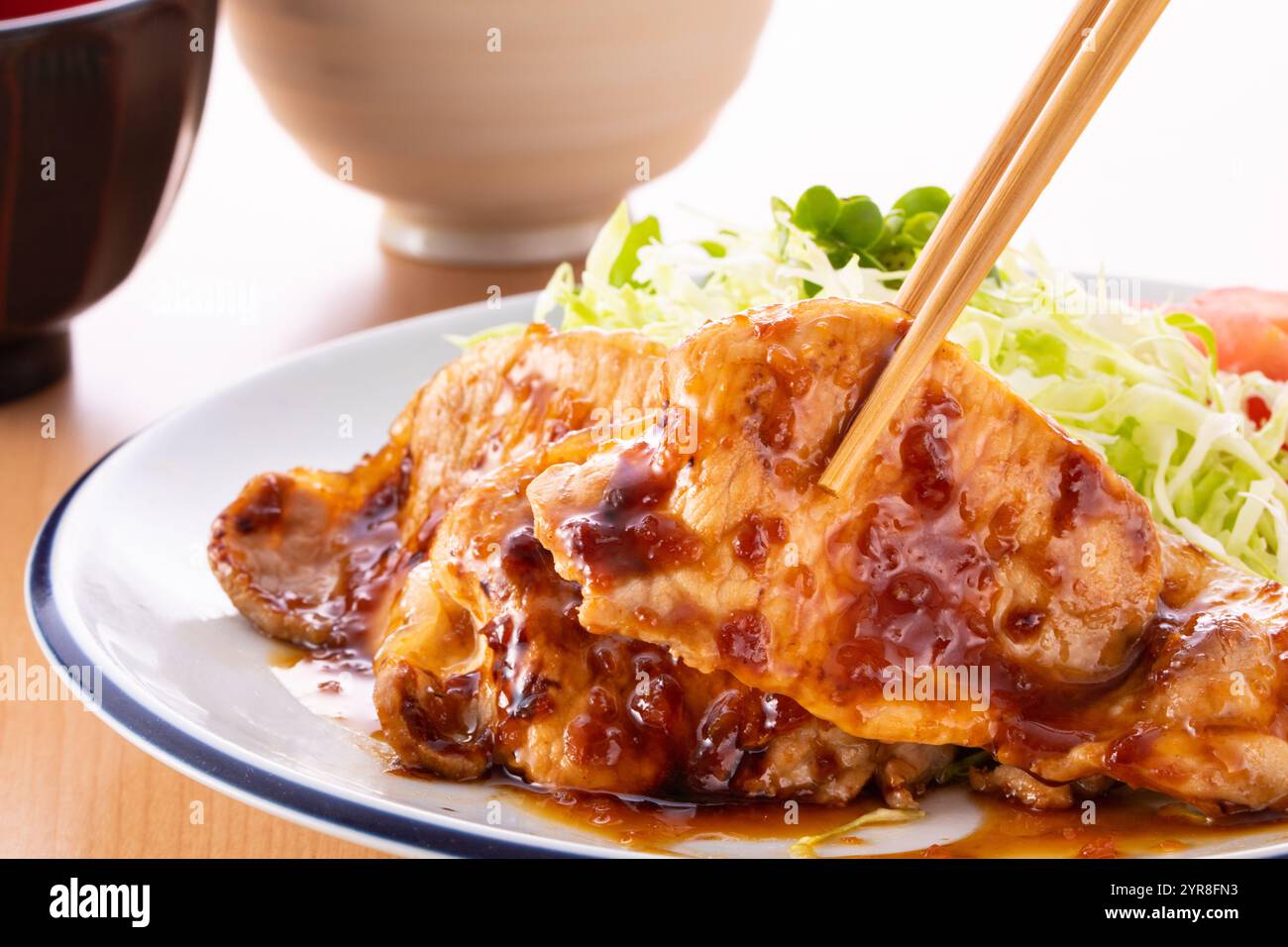 Eating ginger-grilled pork Stock Photo - Alamy