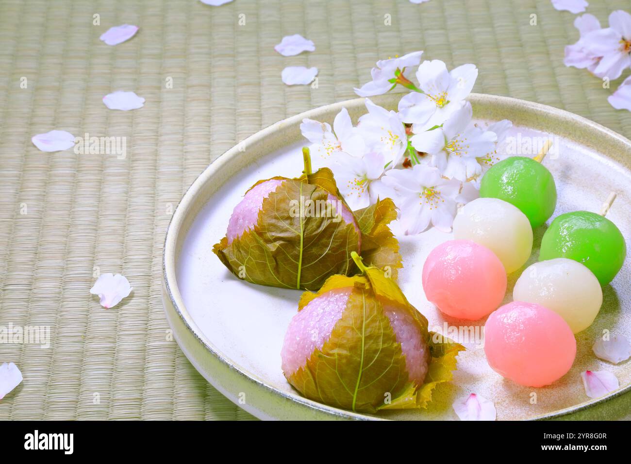 Spring Japanese sweets and cherry petals Stock Photo - Alamy