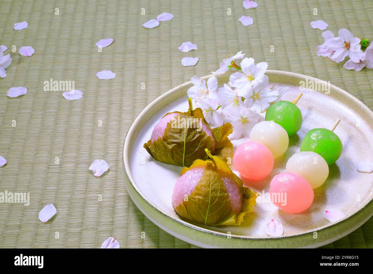 Spring Japanese sweets and cherry petals Stock Photo - Alamy