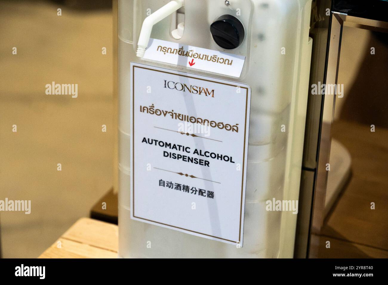 Automatic alcohol dispenser showcased at a bustling venue in Thailand ...