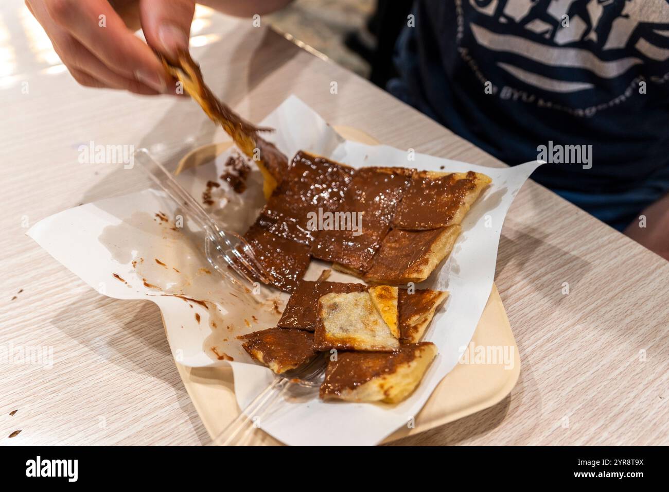 Delicious Thai Roti being savored during a bustling street food evening ...